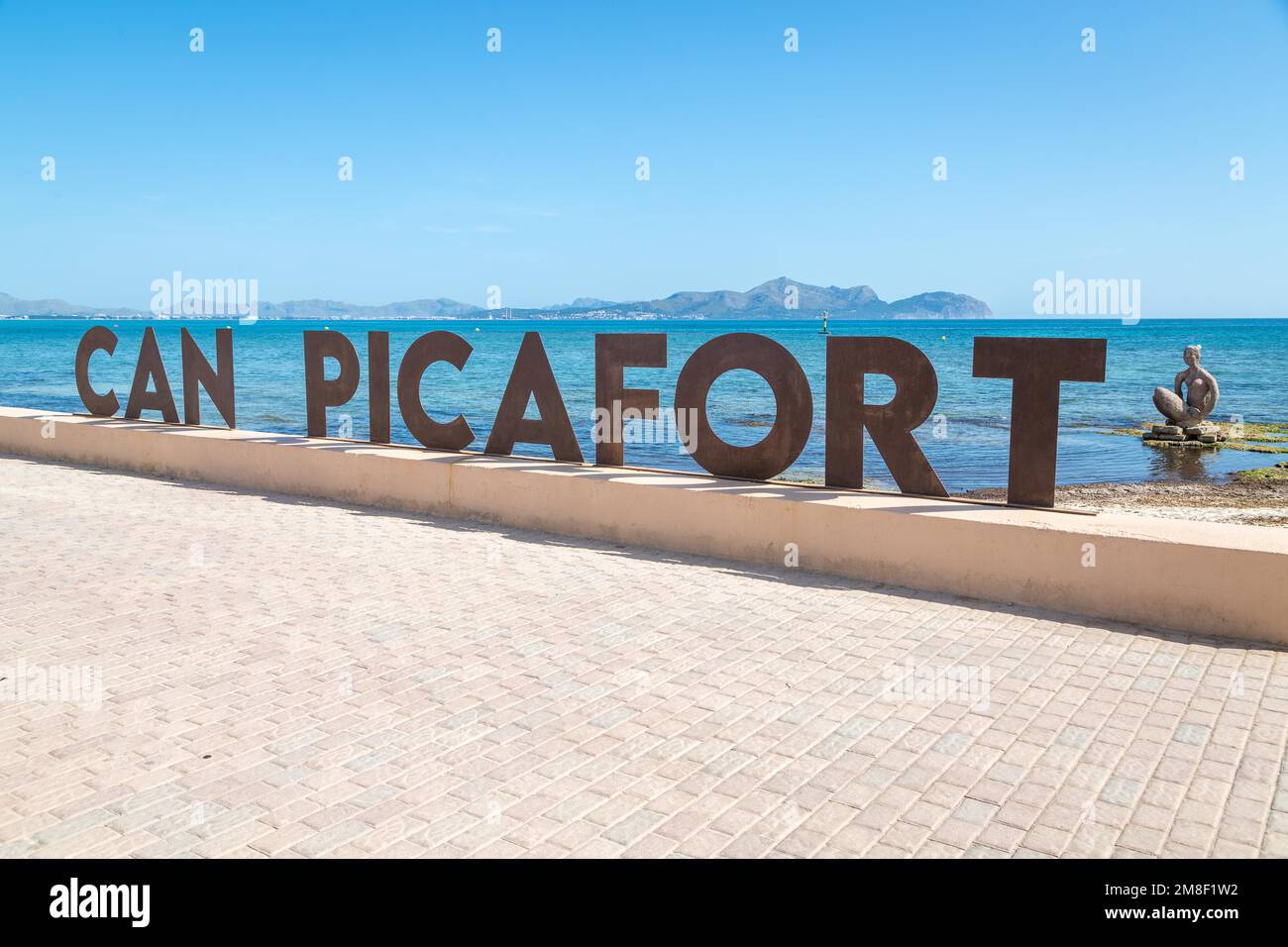 Beach promenade with Can Picafort lettering, sculpture by Joan ...
