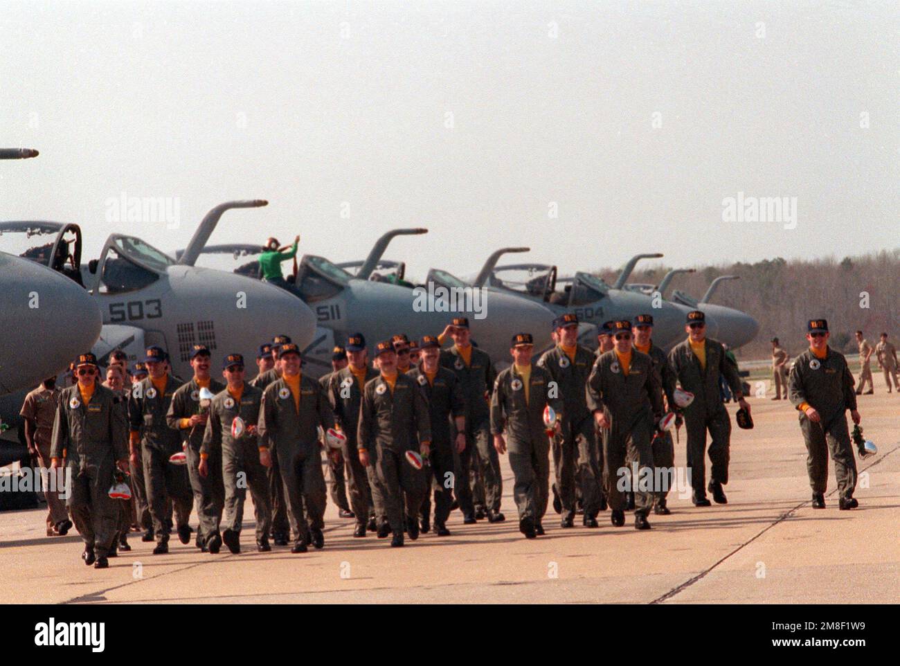 The pilots and bombardier-navigators of Attack Squadron 75 (VA-75) walk ...