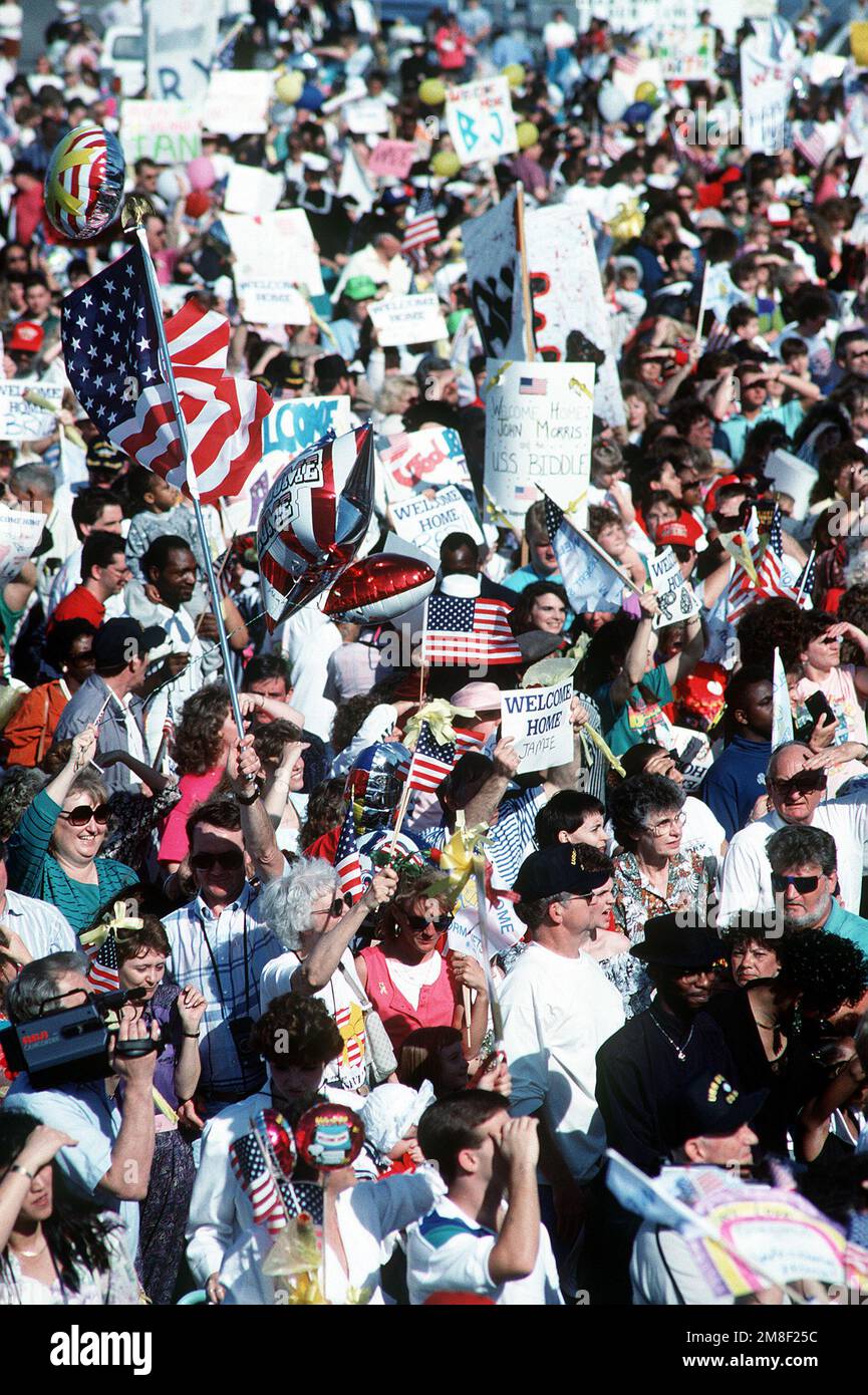 Family members and friends crowd onto the pier to greet the guided ...
