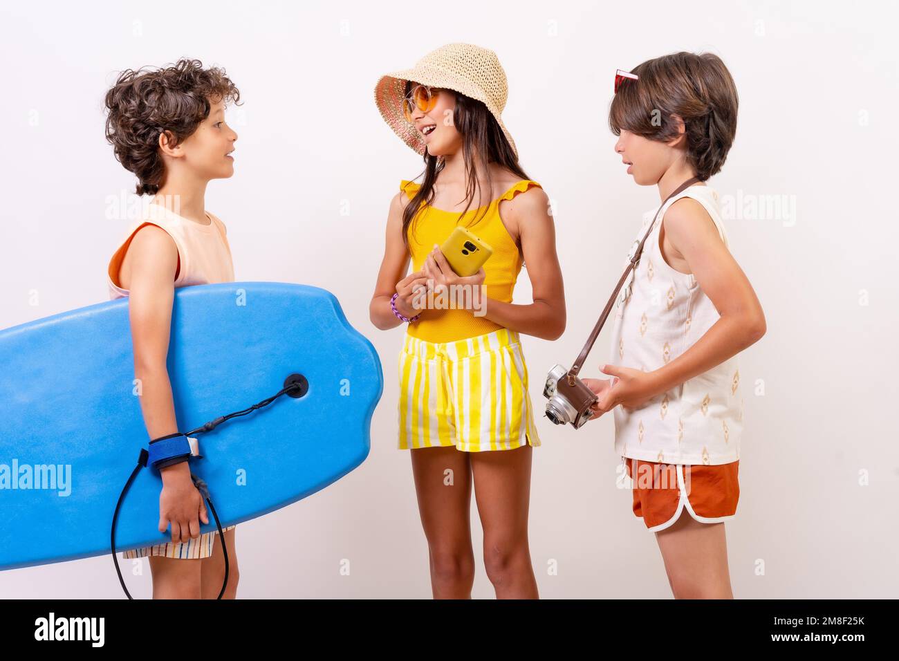 Studio shot of children enjoying summer vacation on a white background ...