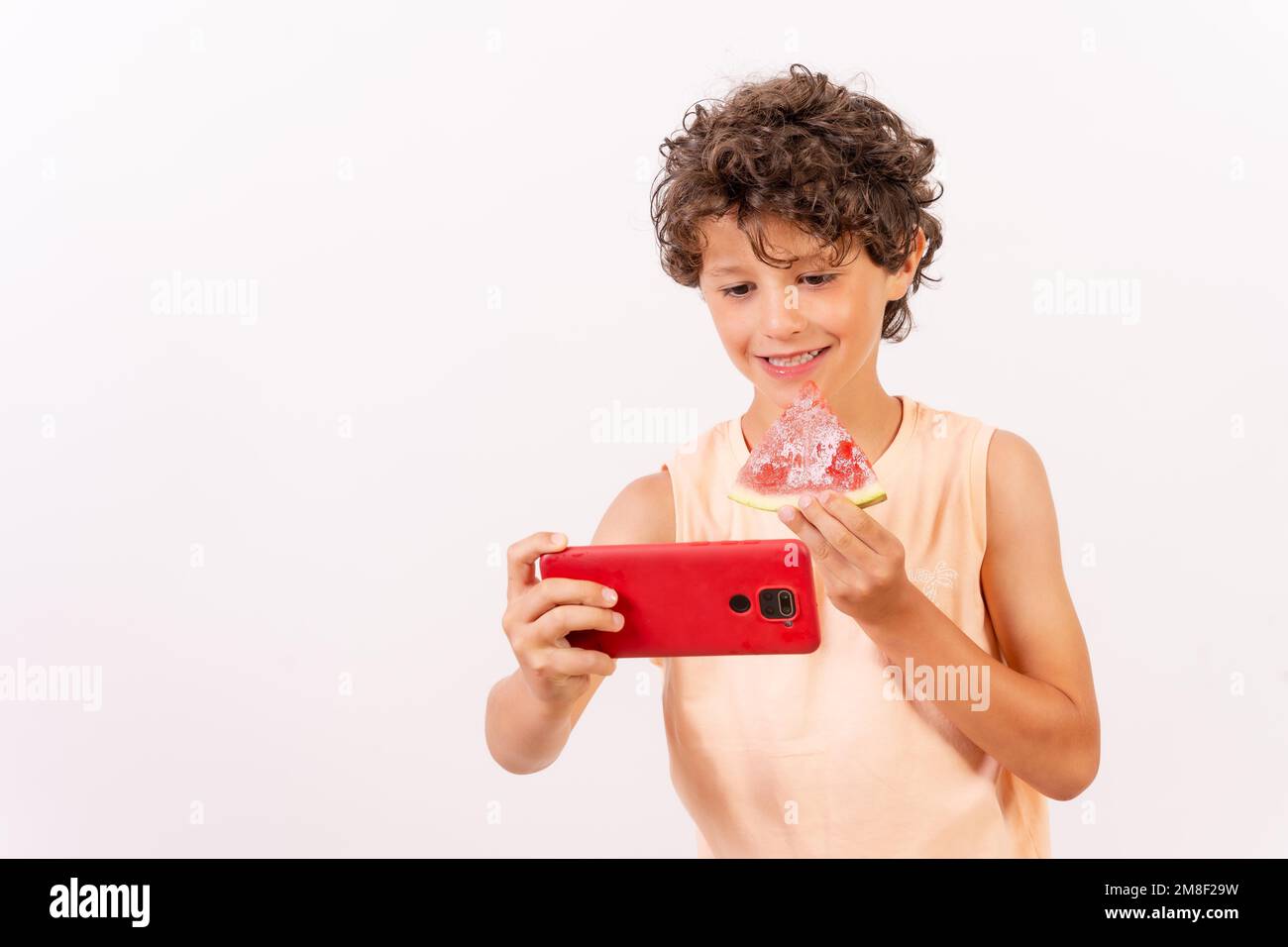 Boy eating a watermelon and taking a selfie, summer vacation. White ...