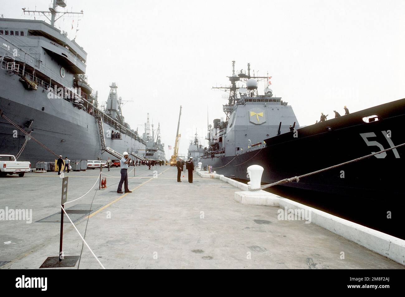 The guided missile cruiser USS THOMAS S. GATES (CG-51) ties up at the ...