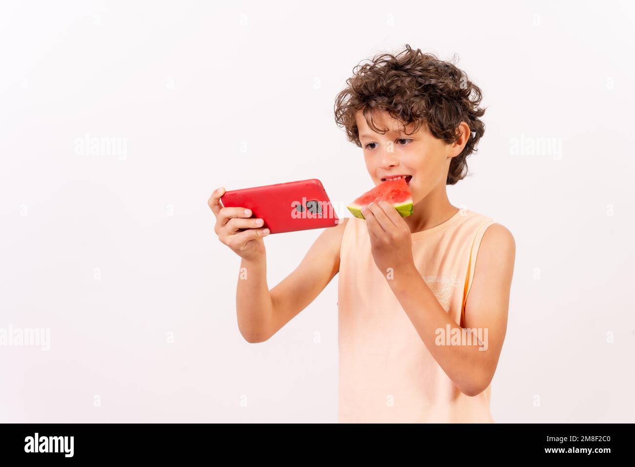 Boy eating a watermelon and taking a selfie, summer vacation. White ...