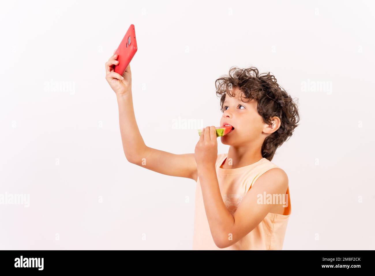 Boy eating a watermelon and taking a selfie, summer vacation. White ...
