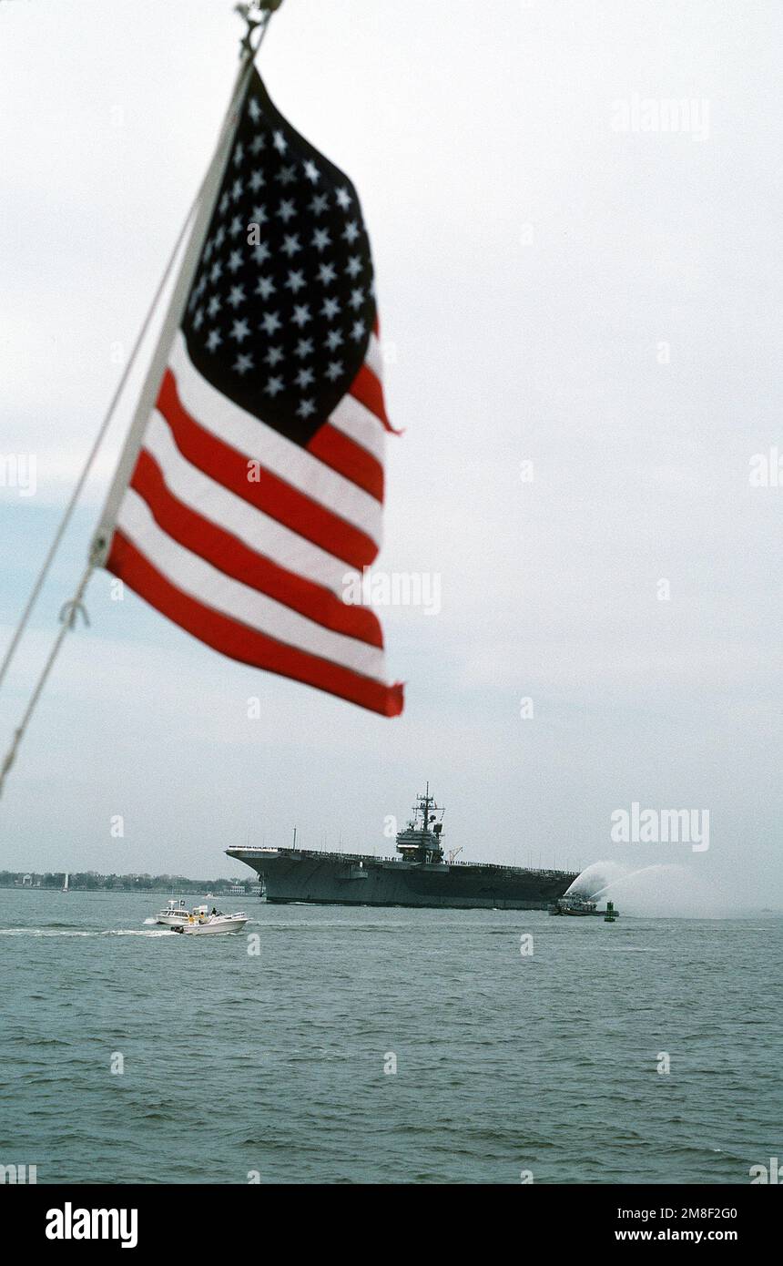The American flag flies from a vessel in the foreground as a large ...