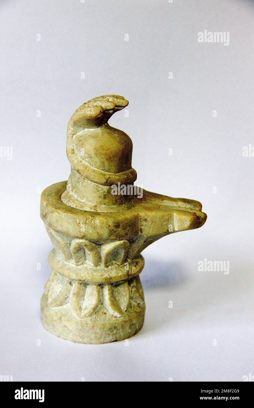 Marble stone icon of Shivaling surrounded by Naga called Nagaling ...