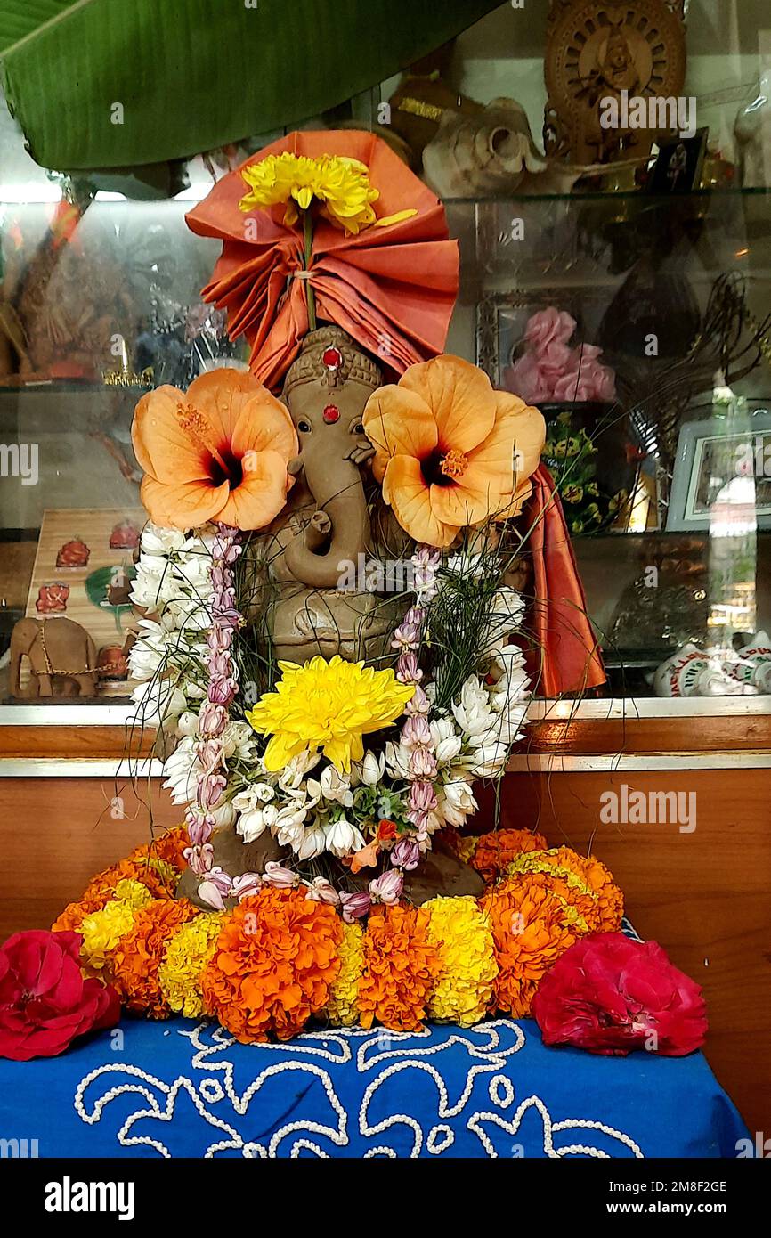 View of Ganesha idol decorated with flowers for performing puja on ...