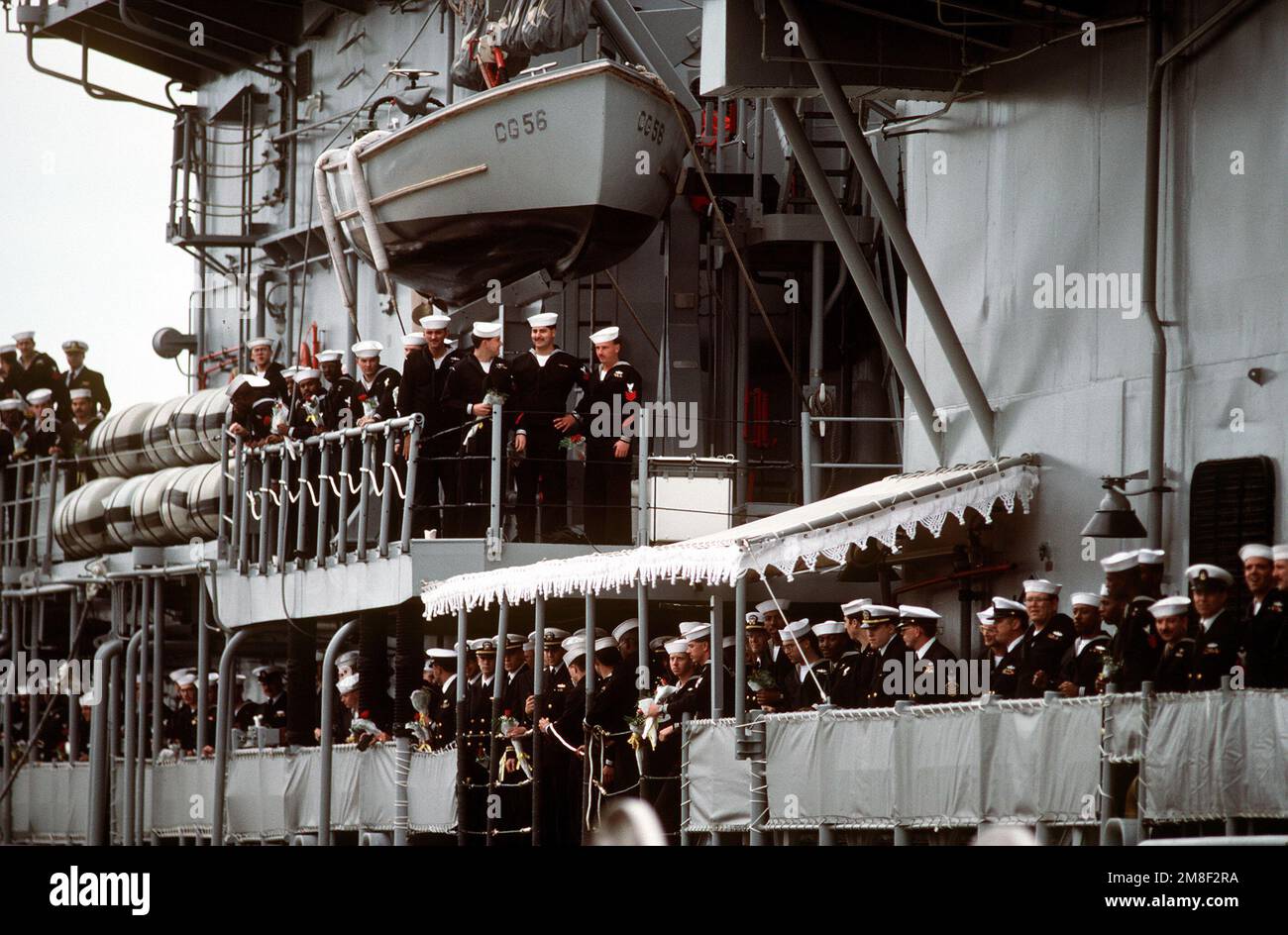 The crew of the guided missile cruiser USS SAN JACINTO (CG-56) lines ...