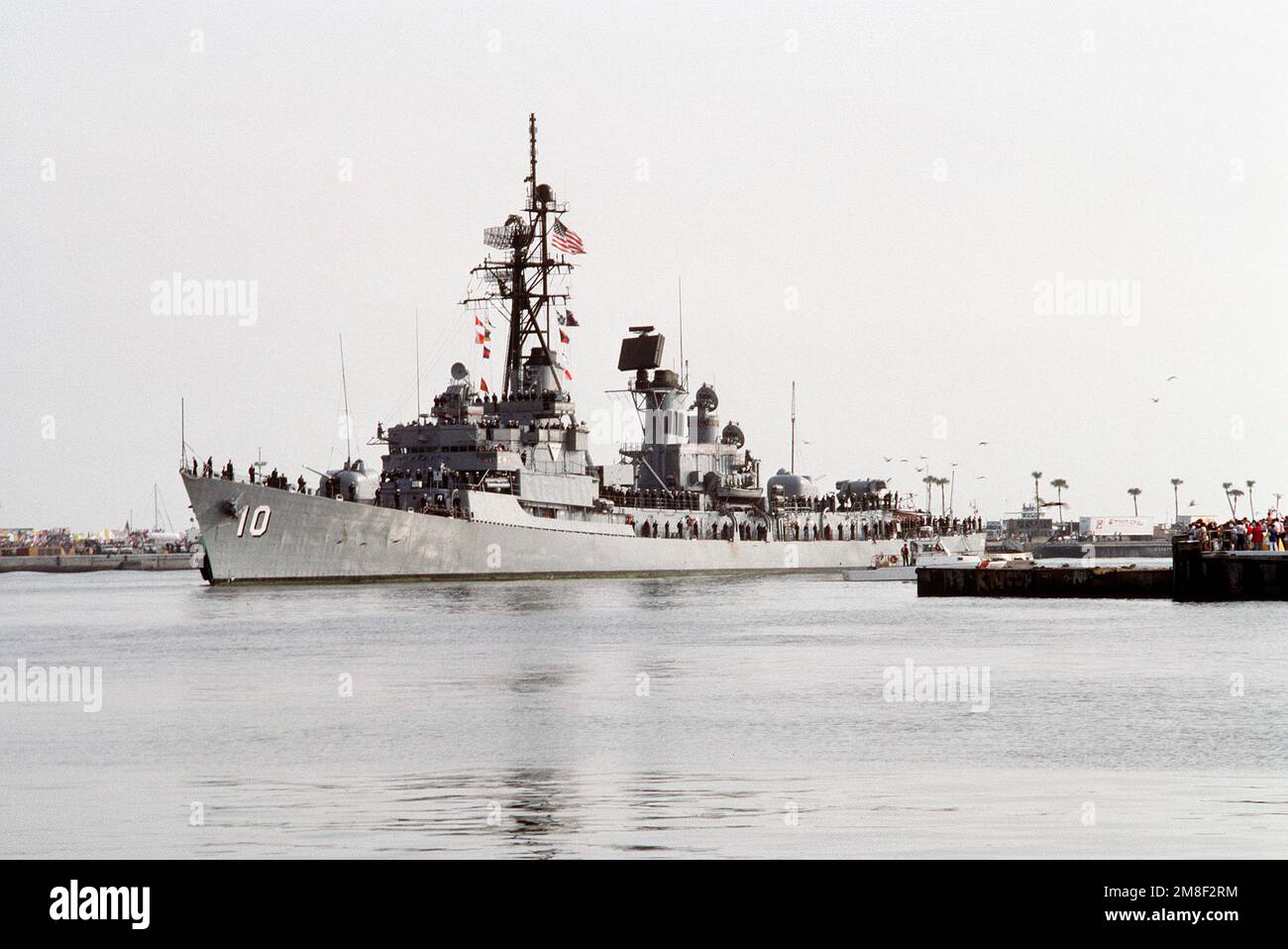 Crew members man the rails aboard the guided missile destroyer USS SAMPSON (DDG-10) as the ship ...