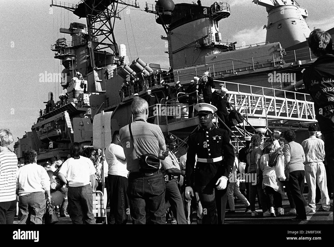 Sailors and Marines from the battleship USS WISCONSIN (BB-64) disembark ...