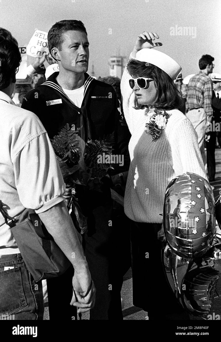 A sailor from the battleship USS WISCONSIN (BB-64) stands with family ...