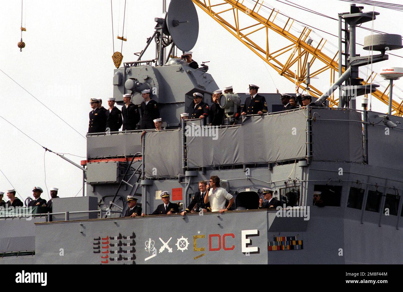 Crew members aboard the frigate USS ELMER MONTGOMERY (FF-1082) look out ...