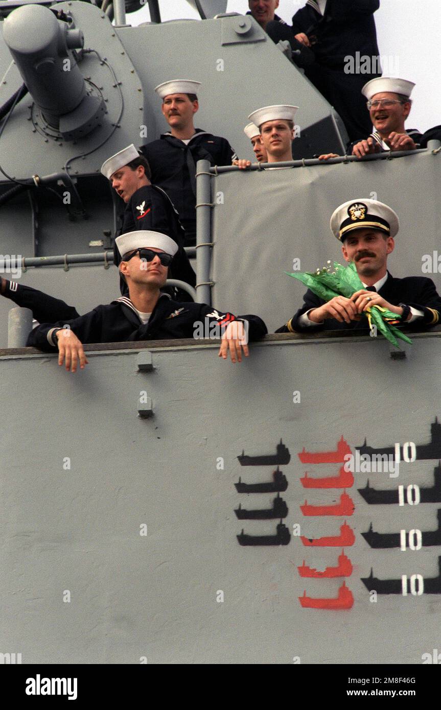 Crew members aboard the frigate USS ELMER MONTGOMERY (FF-1082) look out ...