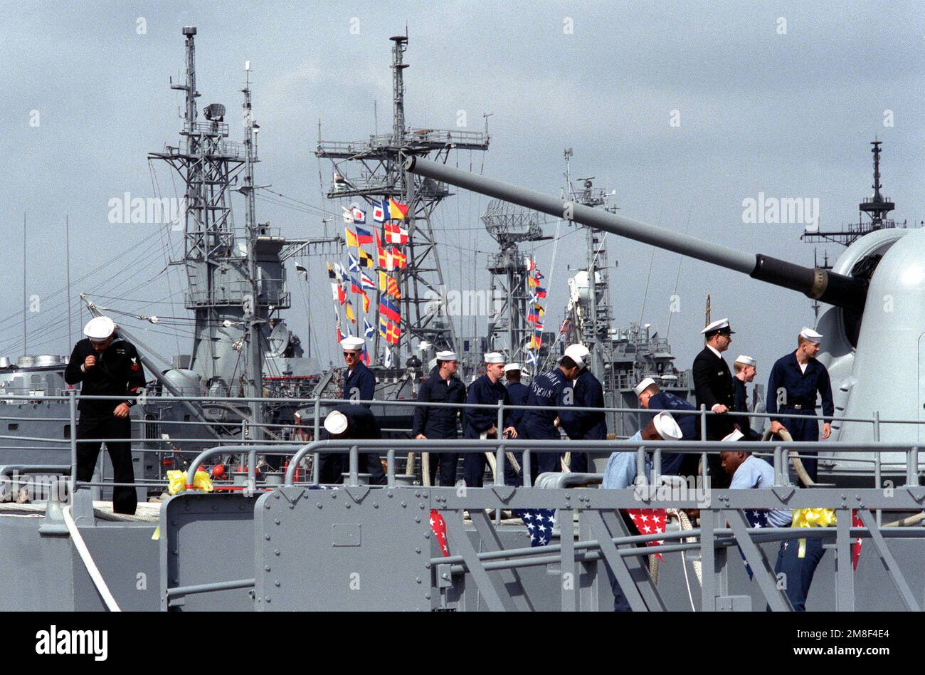 Crew members stand on the stern of the destroyer USS SPRUANCE (DD-963 ...
