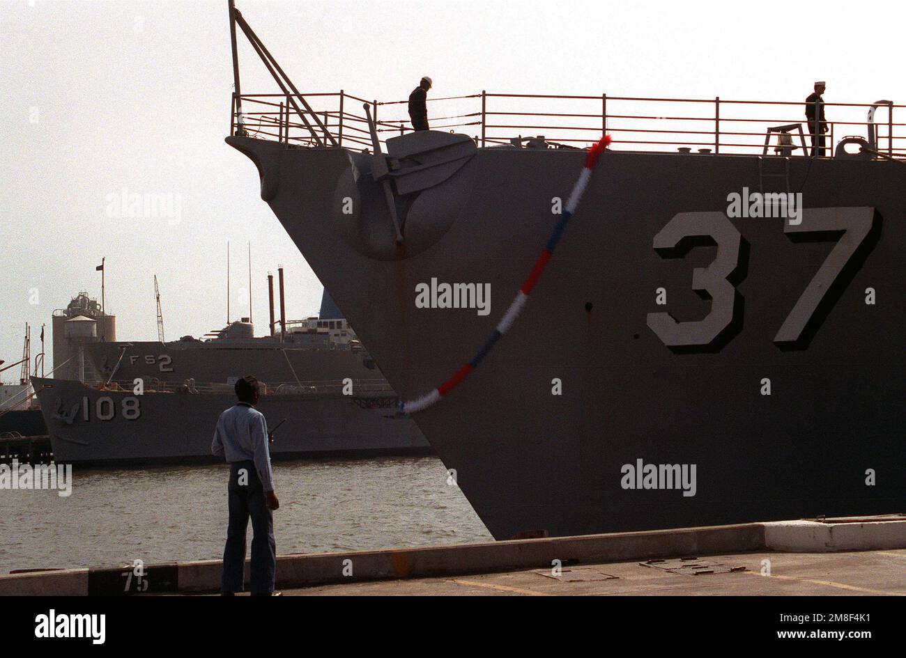A wreath bedecks the bow of the guided missile cruiser USS SOUTH ...
