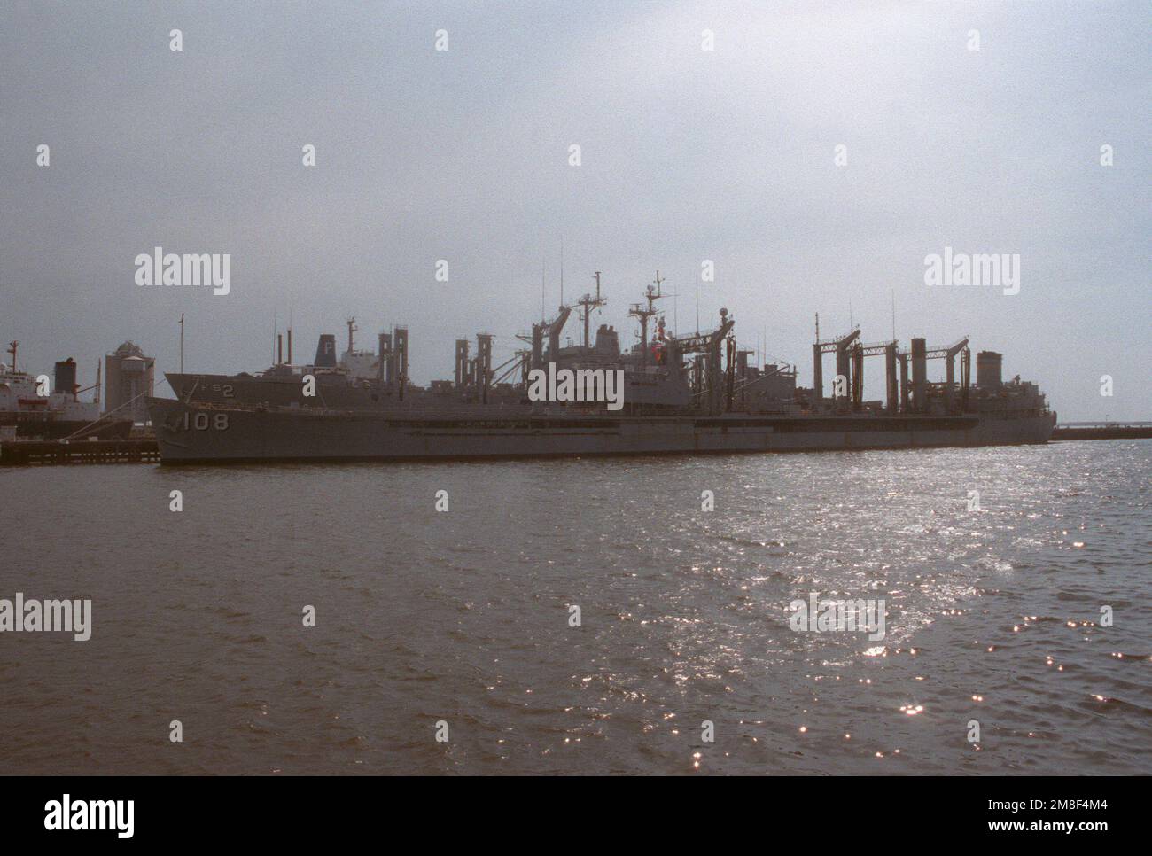A port view of the combat stores ship USS SYLVANIA (AFS-2), background ...