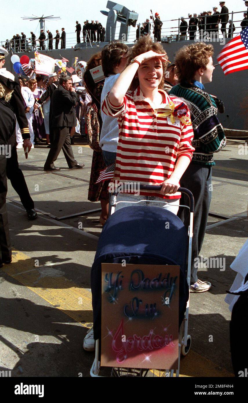 A sign on the baby carriage introduces father to child for the first ...