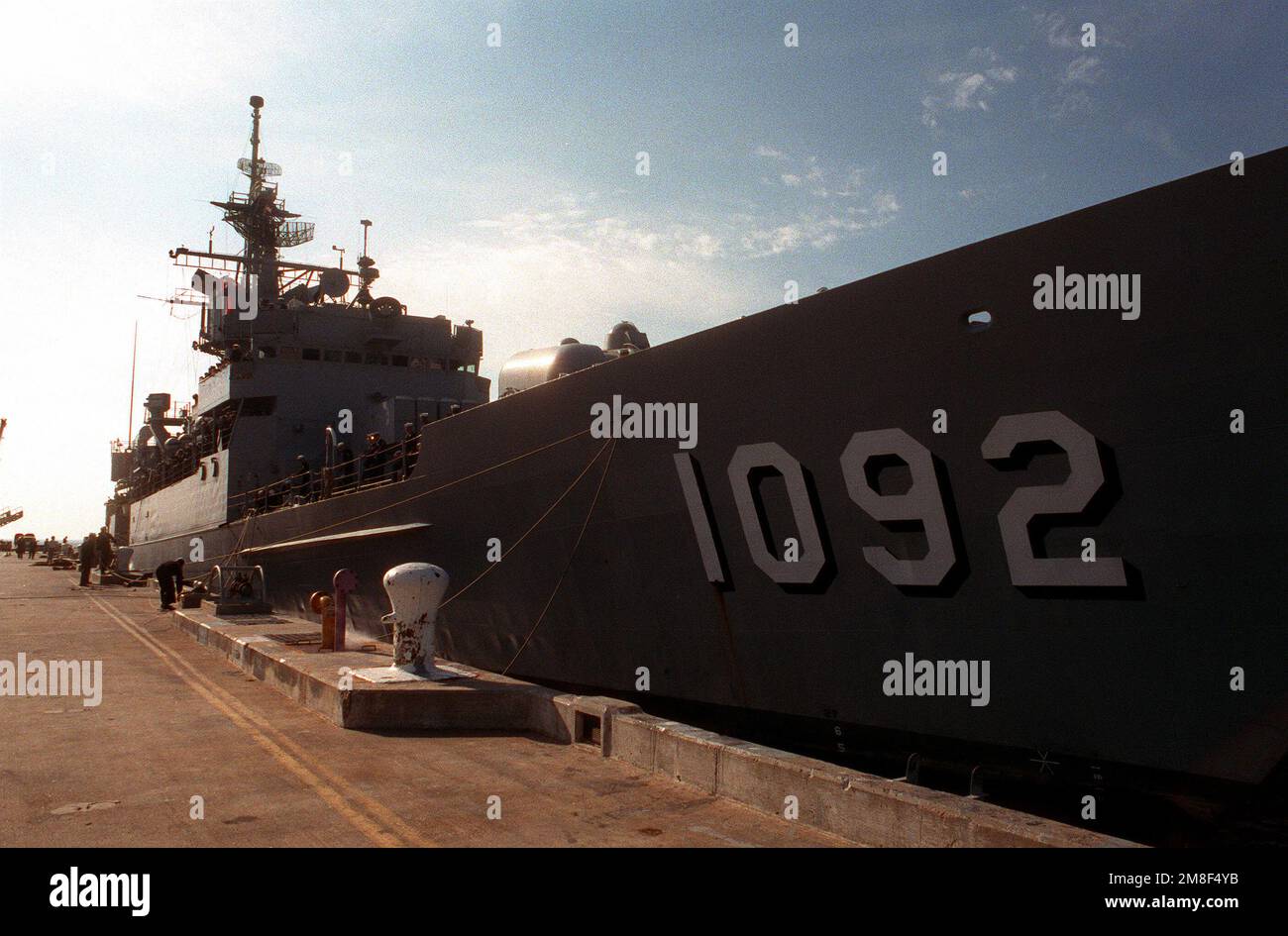A starboard bow view of the frigate USS THOMAS C. HART (FF-1092) moored ...