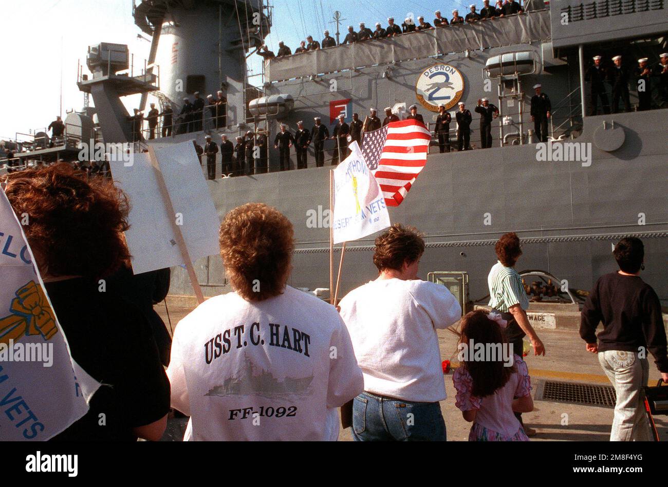 Crew members line the rails aboard the frigate USS THOMAS C. HART (FF ...