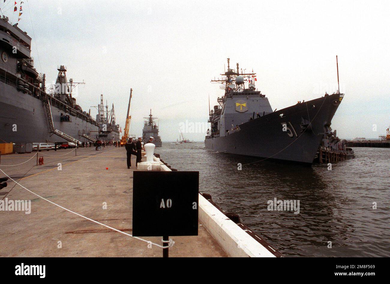 The large harbor tug ANOKA (YTB-810) maneuvers the guided missile ...