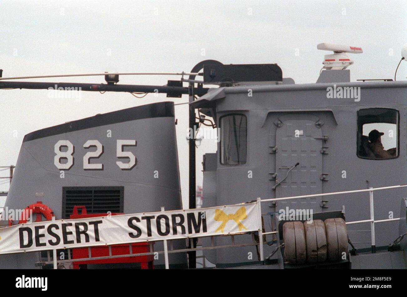 A banner hangs from a railing aboard the large harbor tug WATHENA (YTB ...