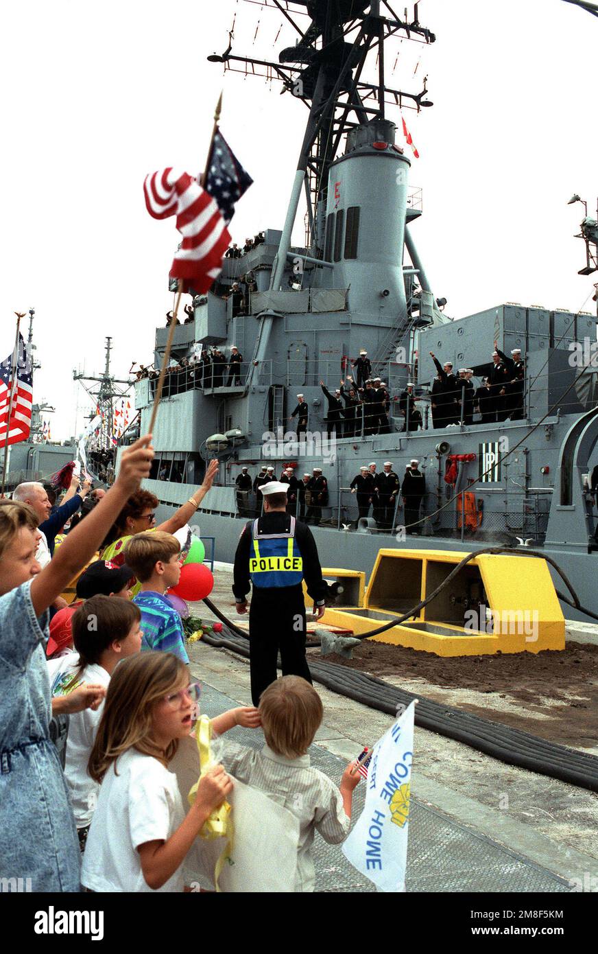 Family members and friends on the pier wave to their loved ones aboard ...
