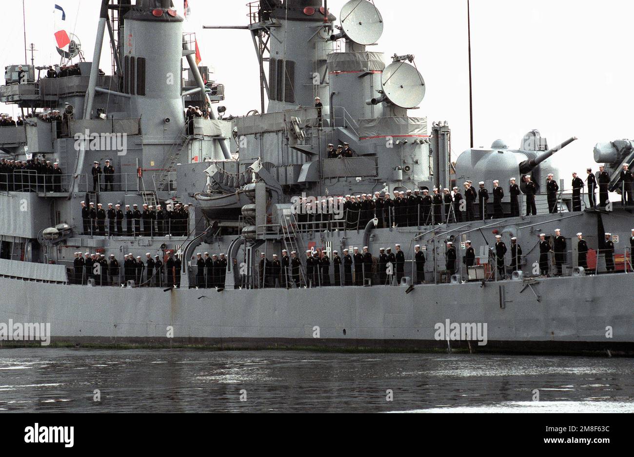 Crew members man the rails aboard the guided missile destroyer USS SAMPSON (DDG-10) as the ship ...