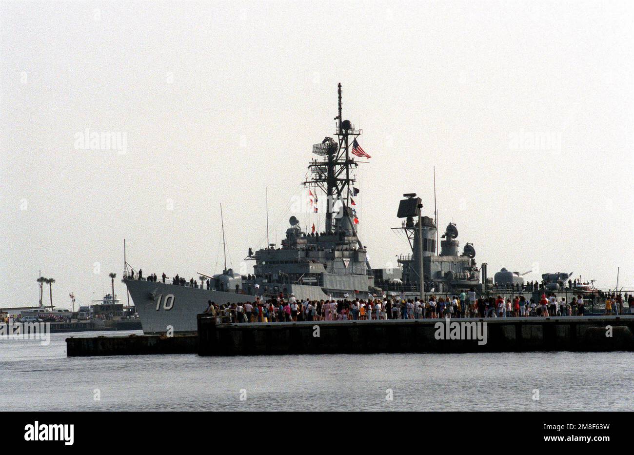 The guided missile destroyer USS SAMPSON (DDG-10) comes alongside the pier as the ship returns ...