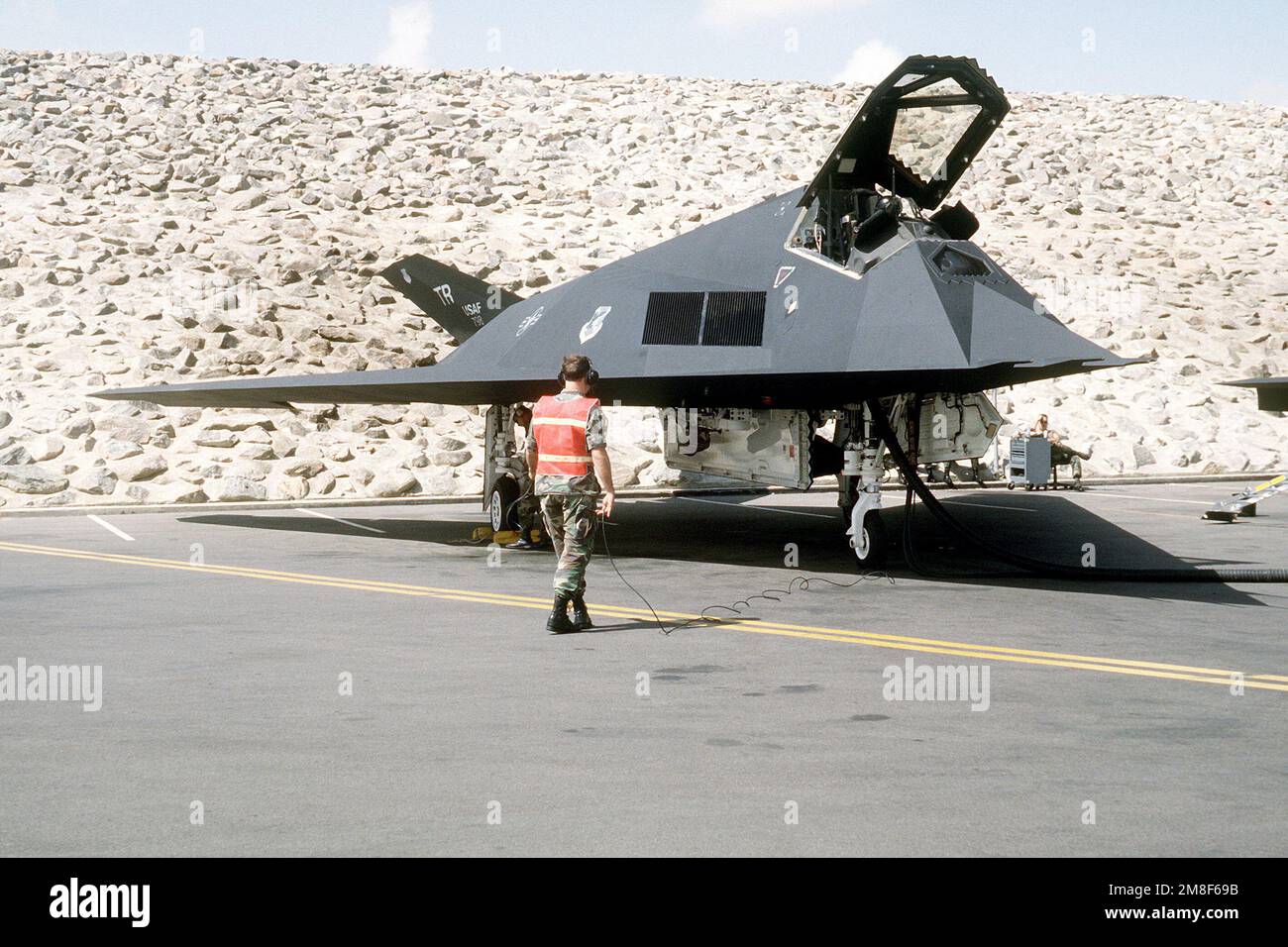 A ground crewman communicates with the pilot of an F-117A stealth ...