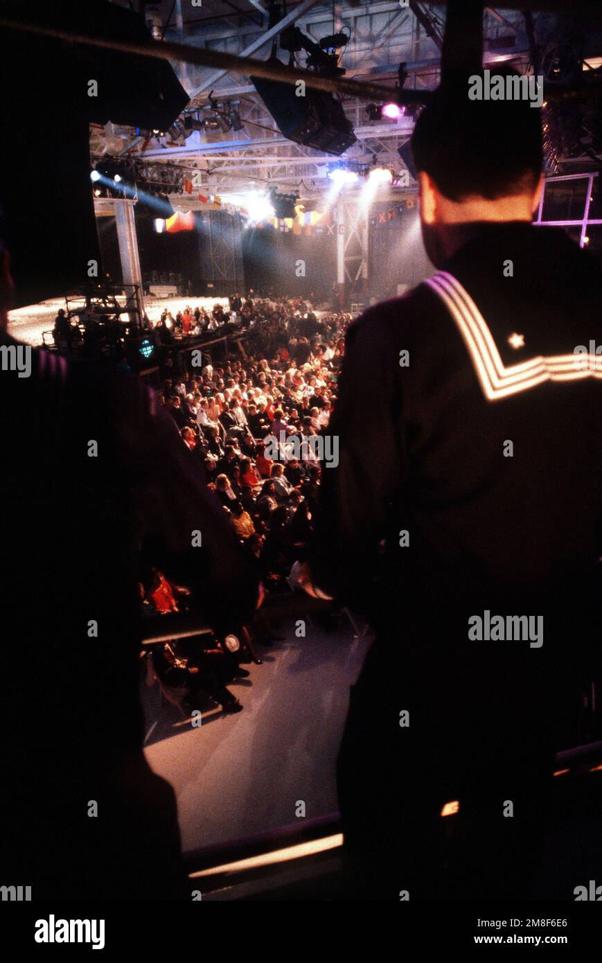 An audience of military personnel and dependents listens as singer ...