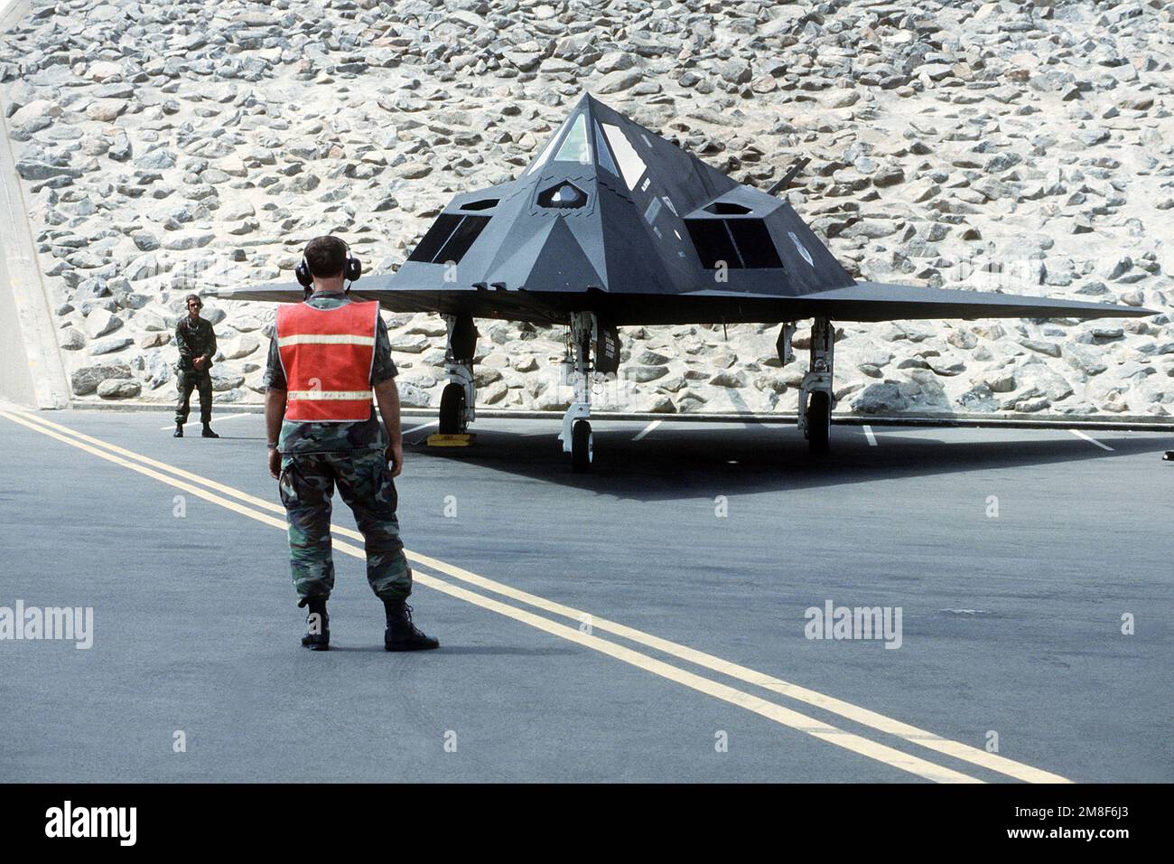 A ground crewman communicates with the pilot of an F-117A stealth ...