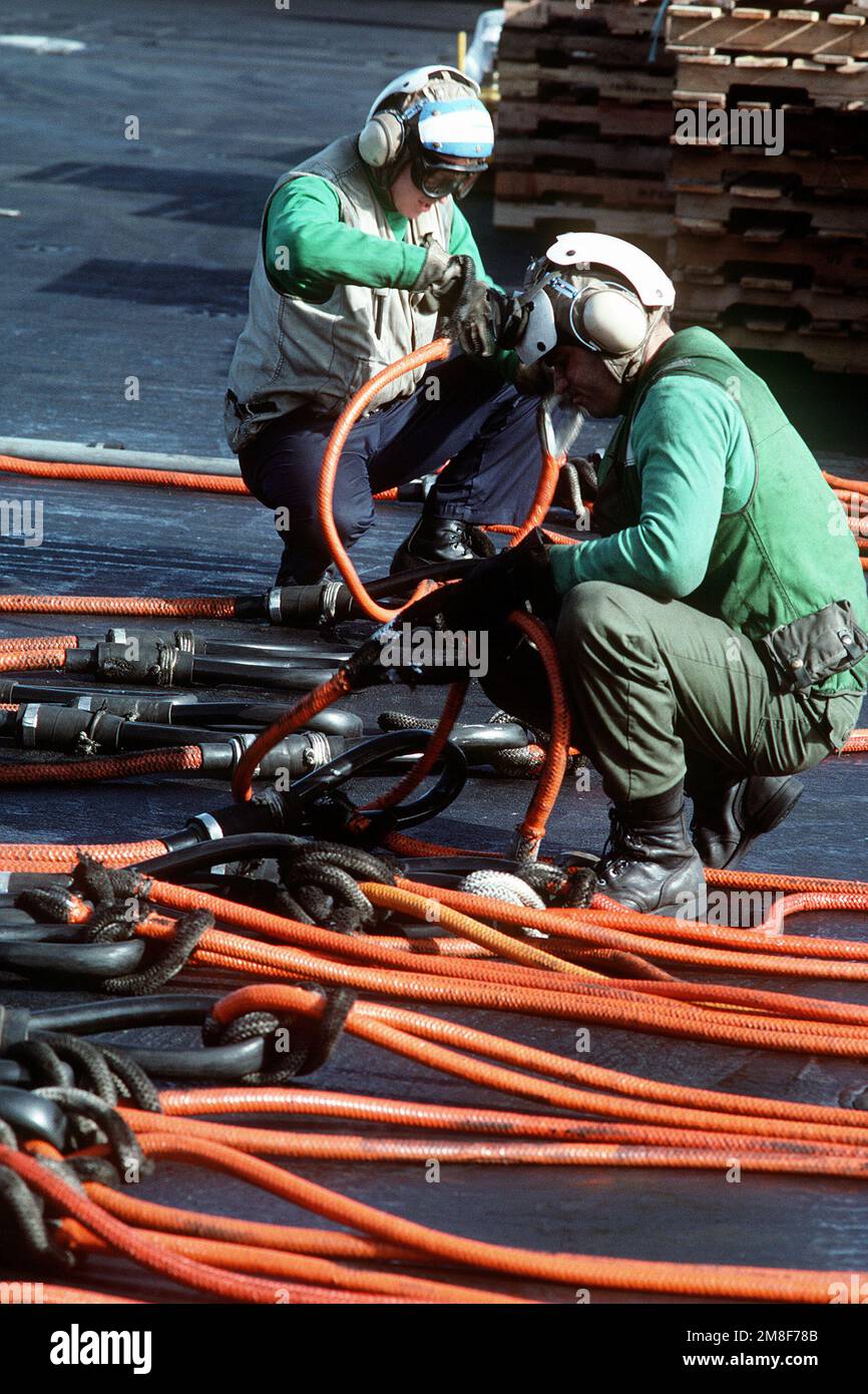 Flight deck crewmen aboard the aircraft carrier USS RANGER (CV-61 ...