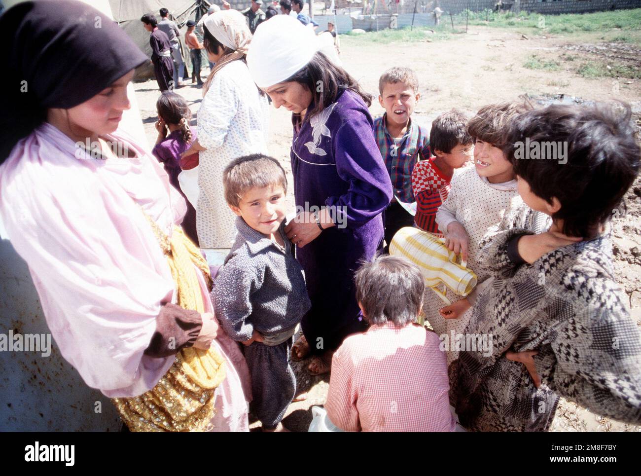 Kurdish refugee children prepare to take containers to a well at their ...