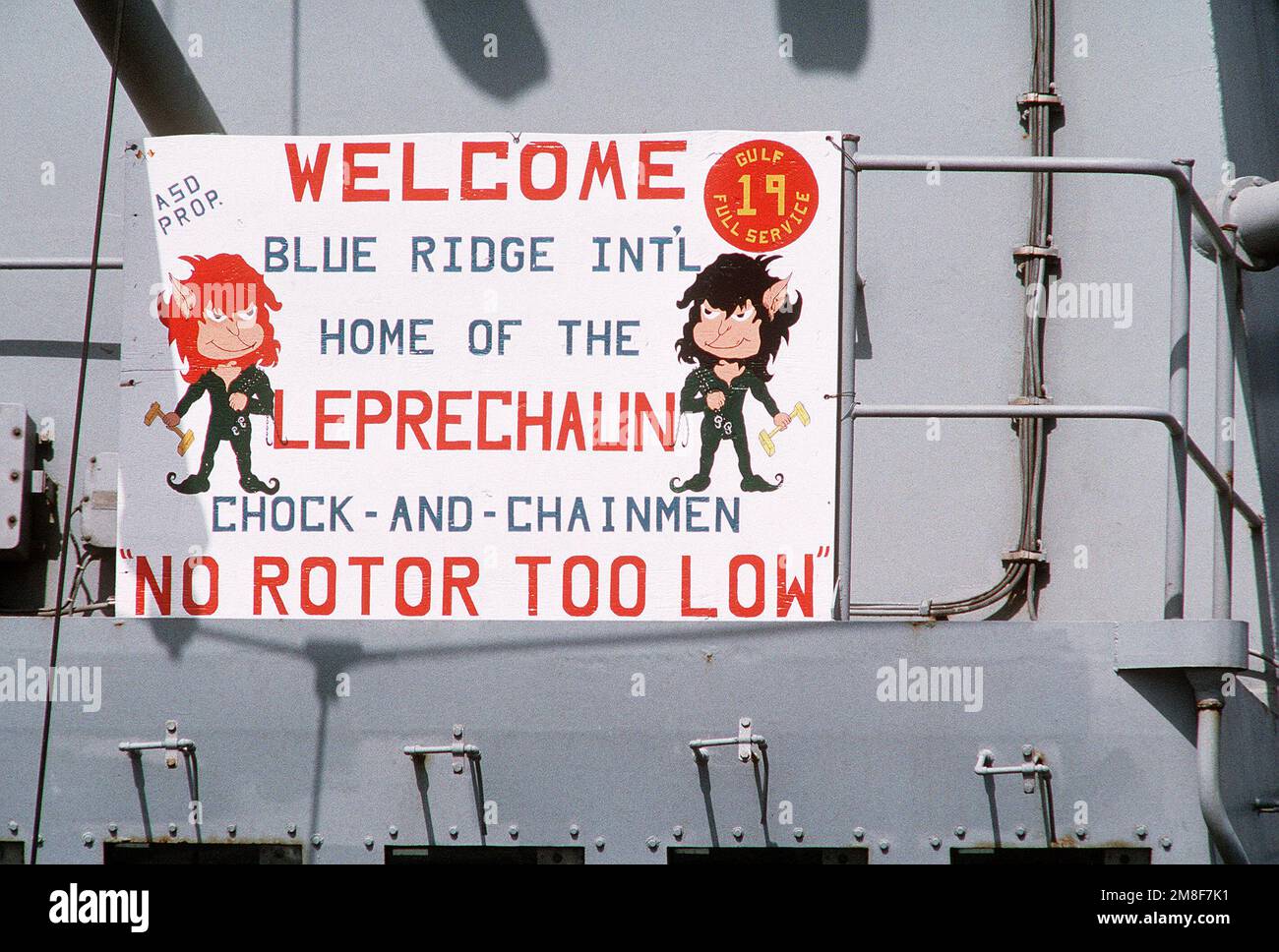A comic sign decorates the helicopter area aboard the amphibious ...