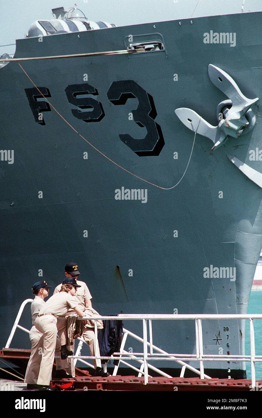 Crew members from the repair ship USS JASON (AR-8) stand on the pier ...