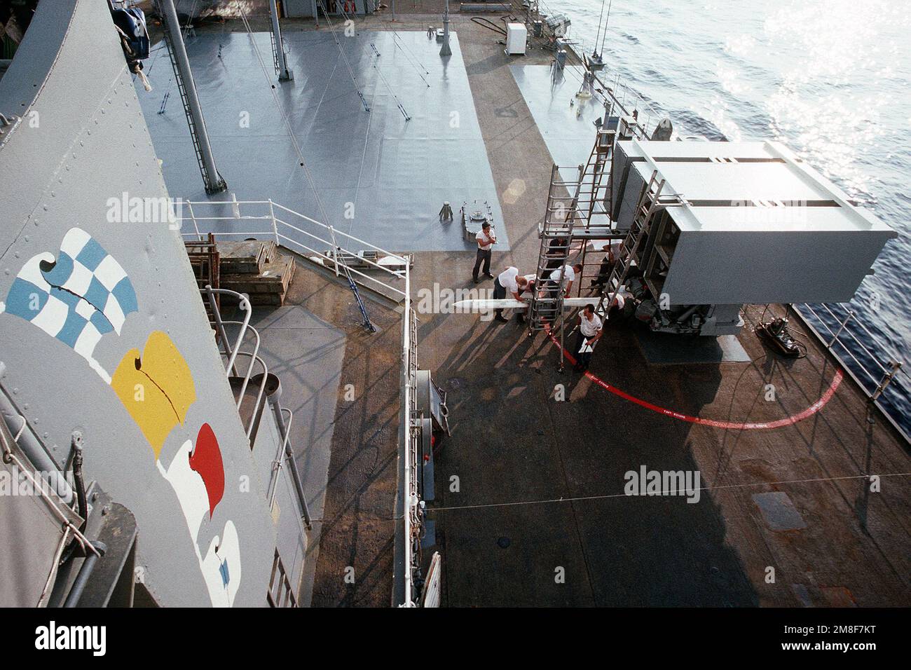 A RIM-7 Sea Sparrow missile is loaded into a Mark 25 launcher aboard ...