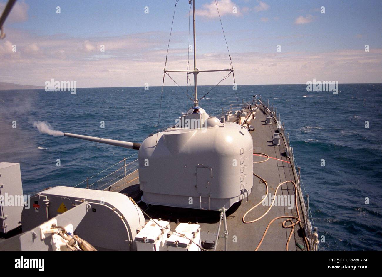 A Mark 42 5-inch/54-caliber gun is fired aboard the guided missile ...
