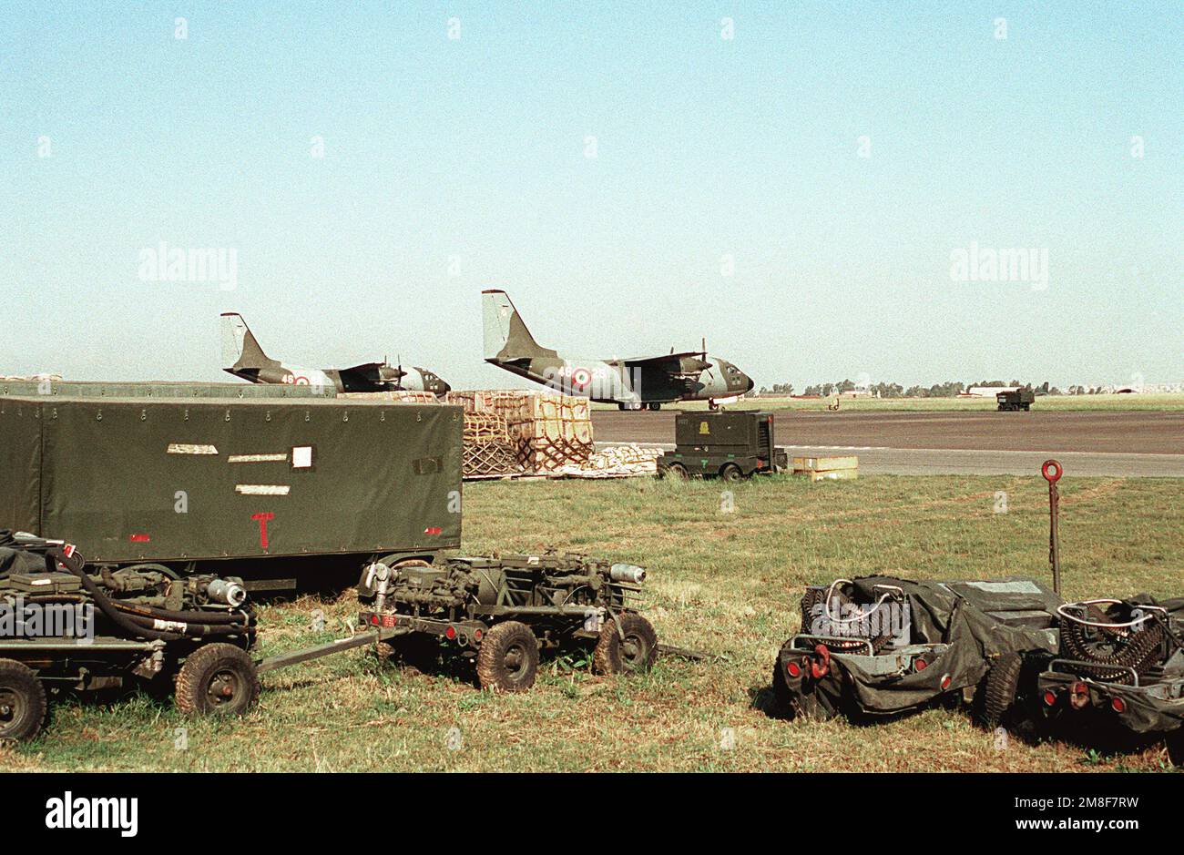 Italian C-222 aircraft stand on the flight line during Operation ...