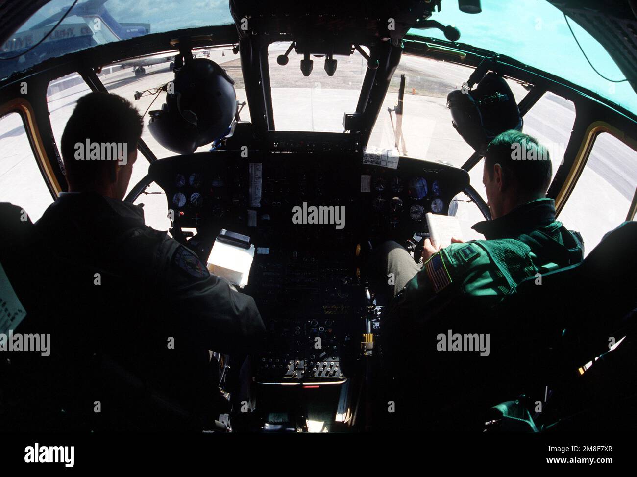 The pilot and co-pilot of a 71st Air Rescue Squadron (71st ARS) HH-3E ...
