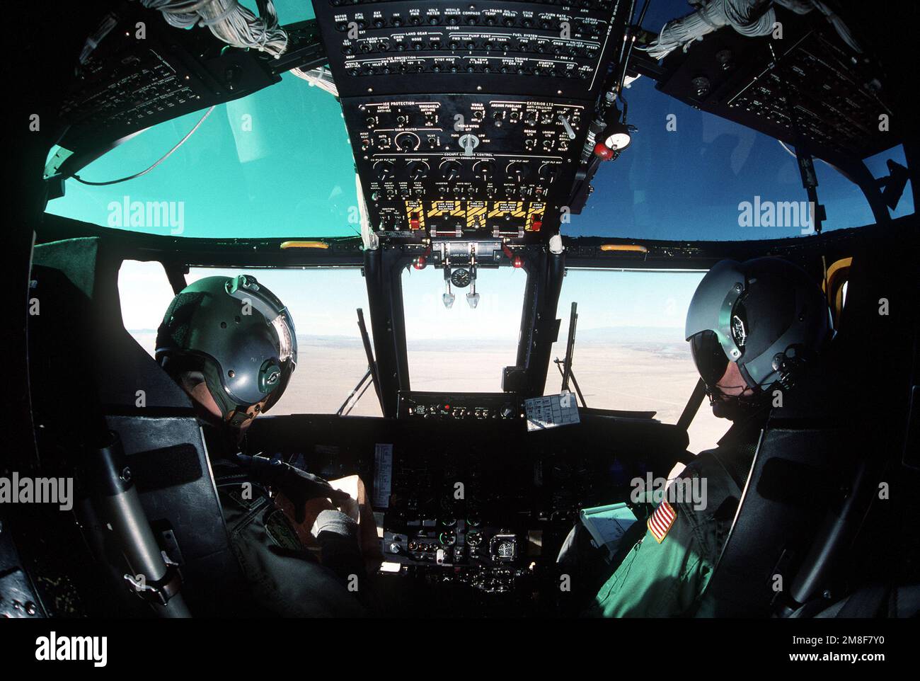 MAJ Richard C. Prien, pilot, and CPT John F. Hozey, co-pilot, review ...