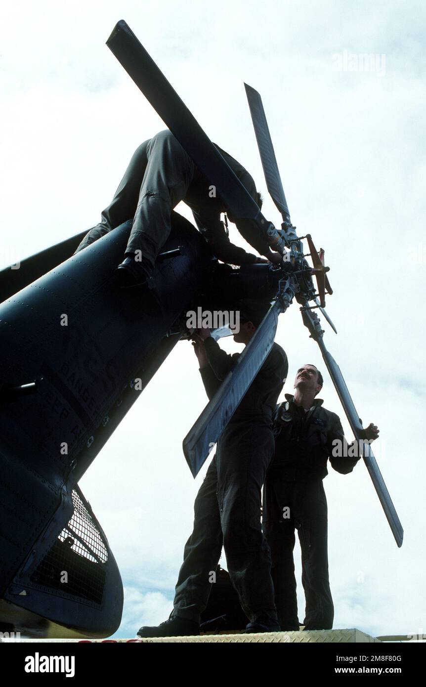 Crew chiefs work on the tail rotor of a 71st Air Rescue Squadron (71st ...
