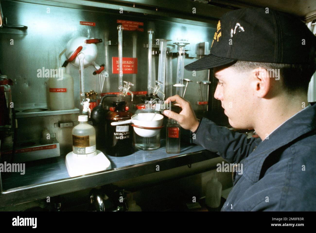 A petty officer on watch as oil king tests a fuel oil sample in an ...