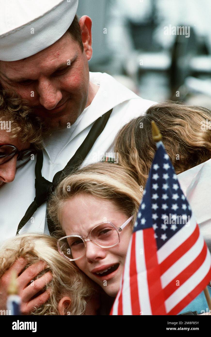 A sailor from the replenishment oiler USS KALAMAZOO (AOR-6) is reunited ...