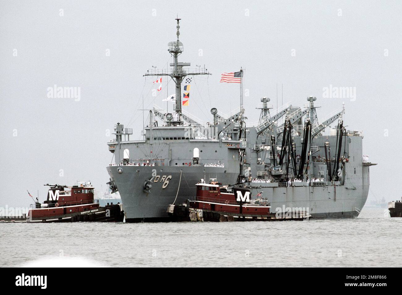 Commercial harbor tugs maneuver the replenishment oiler USS KALAMAZOO ...