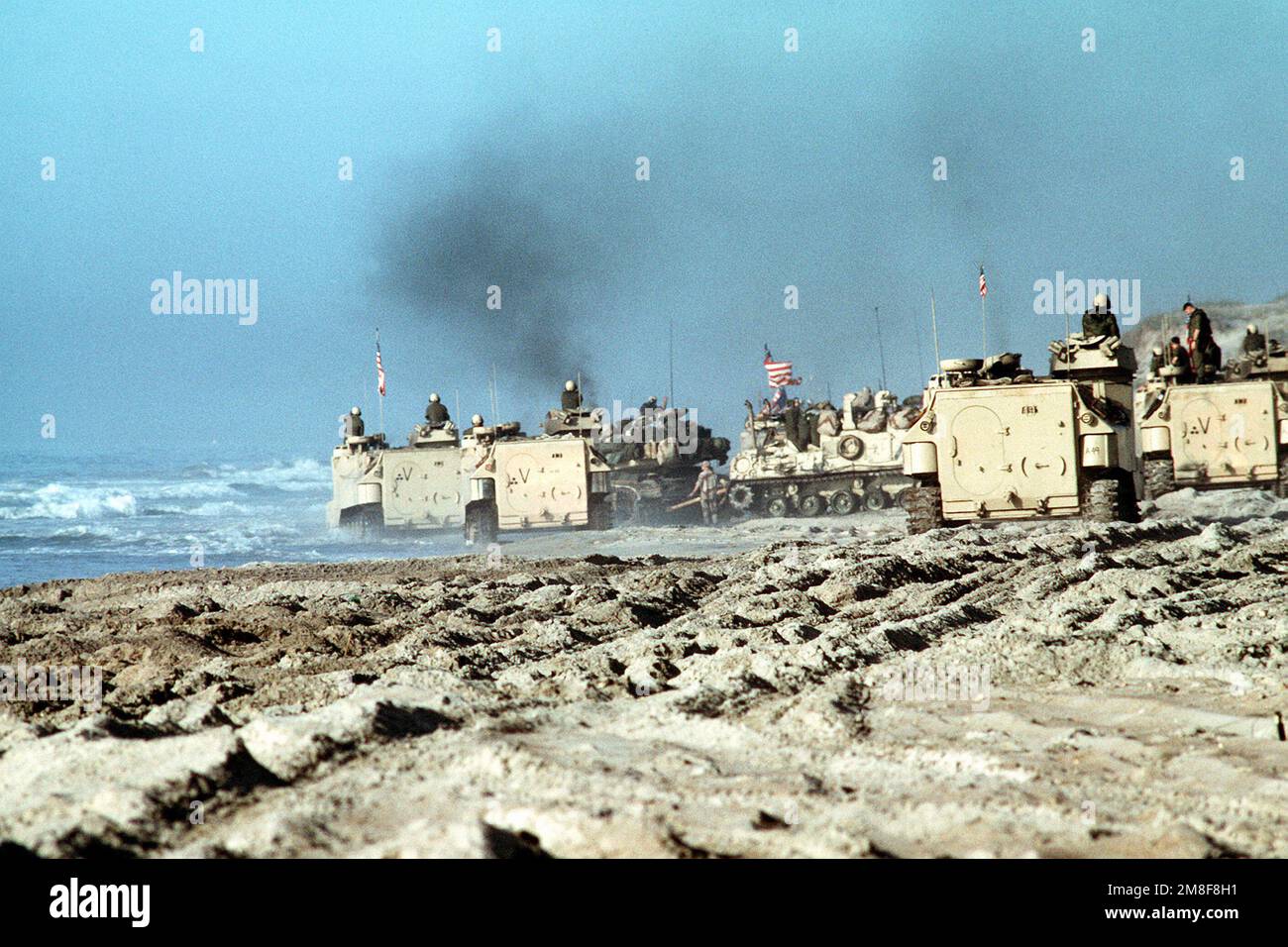 An M-88A1 armored recovery vehicle assists a stalled M-60A1 tank from ...