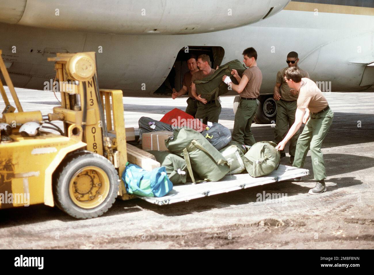Members of Cargo Handler Battalion 9 load personal belongings onto a C ...