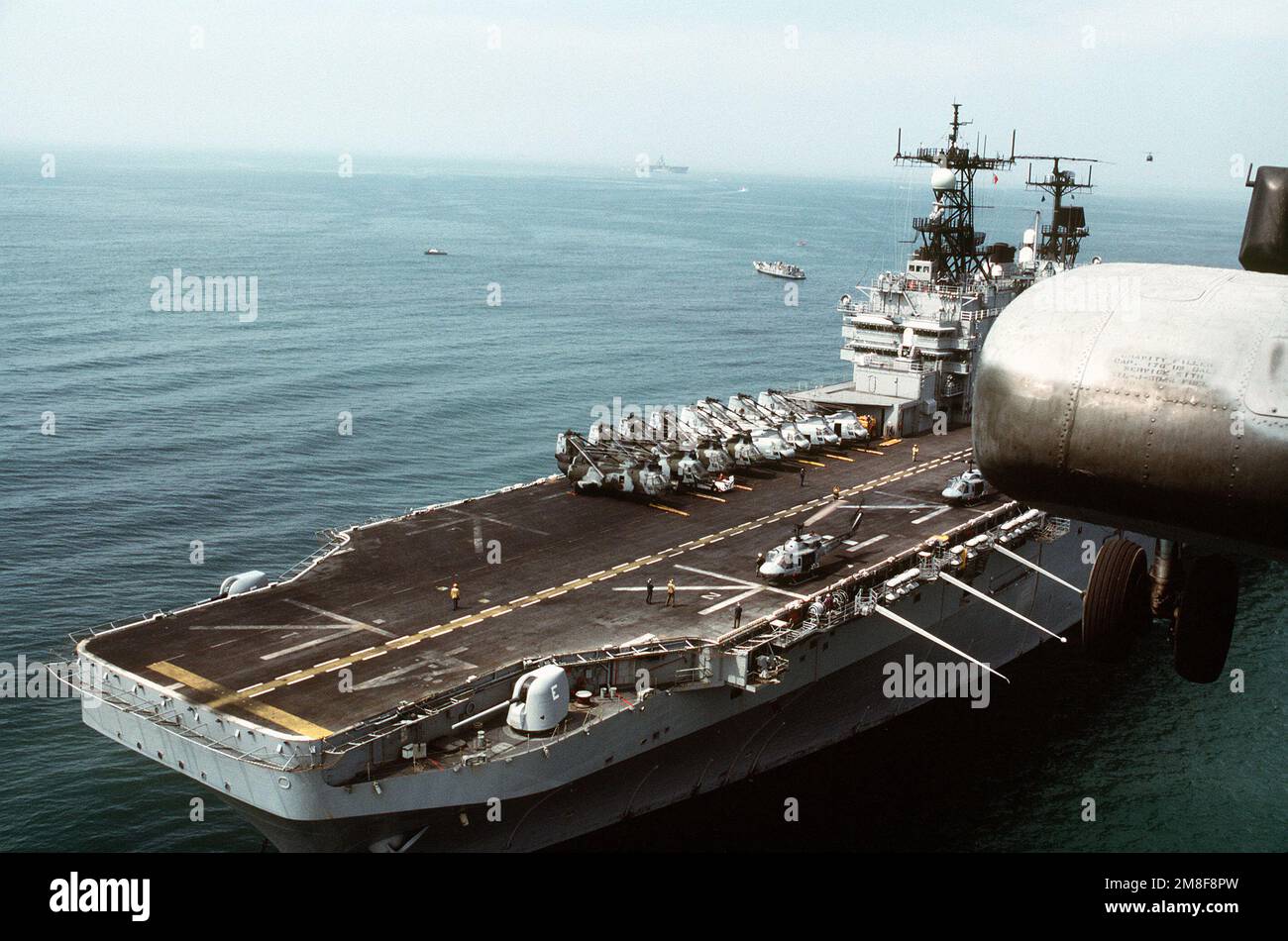 As seen from a departing helicopter, the amphibious assault ship USS ...