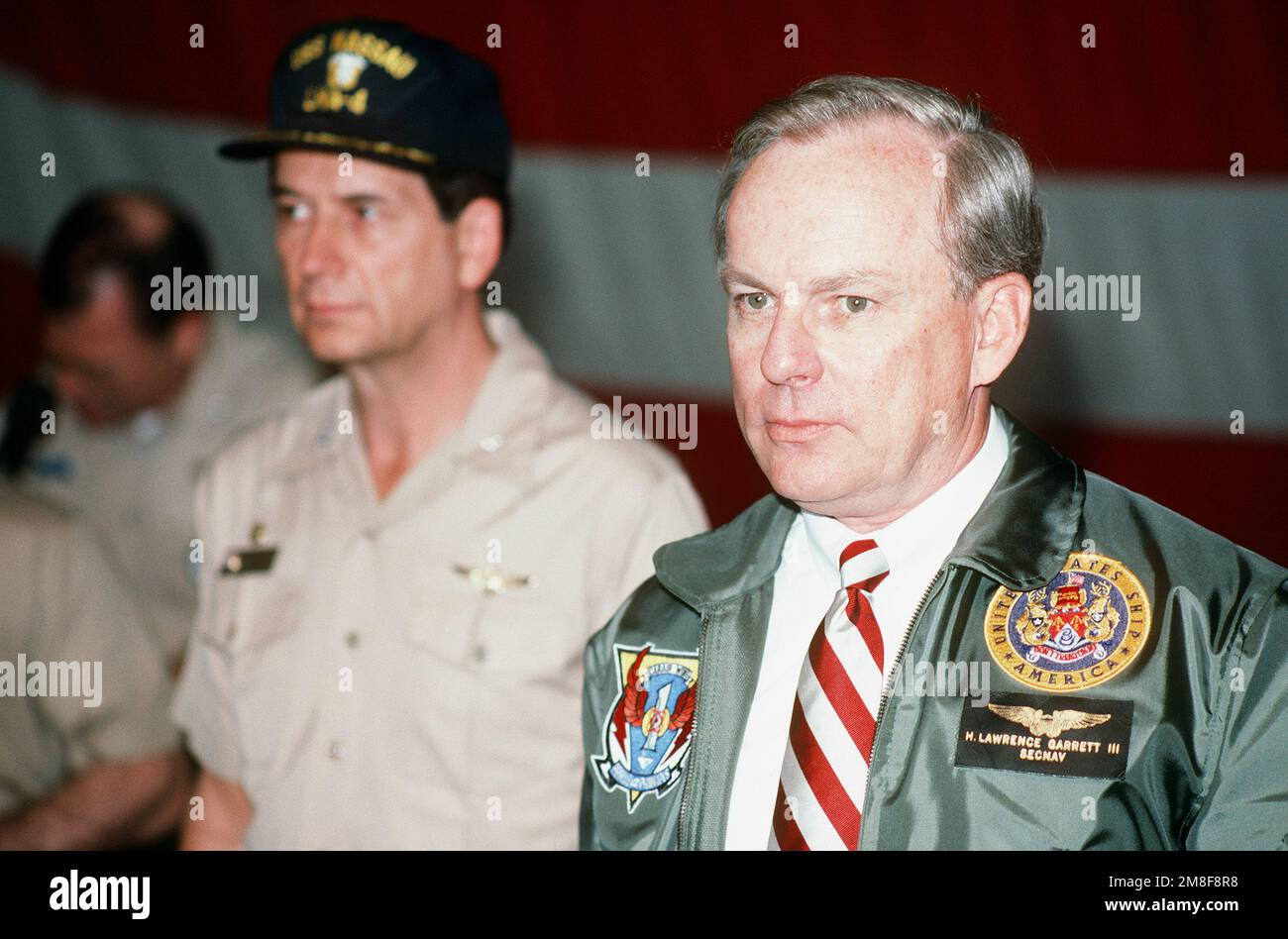 Secretary of the Navy H. Lawrence Garrett III is met by a group of ...