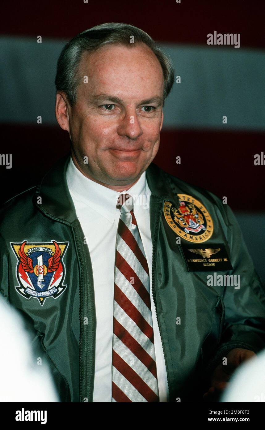 Secretary of the Navy H. Lawrence Garrett III greets a member of the ...