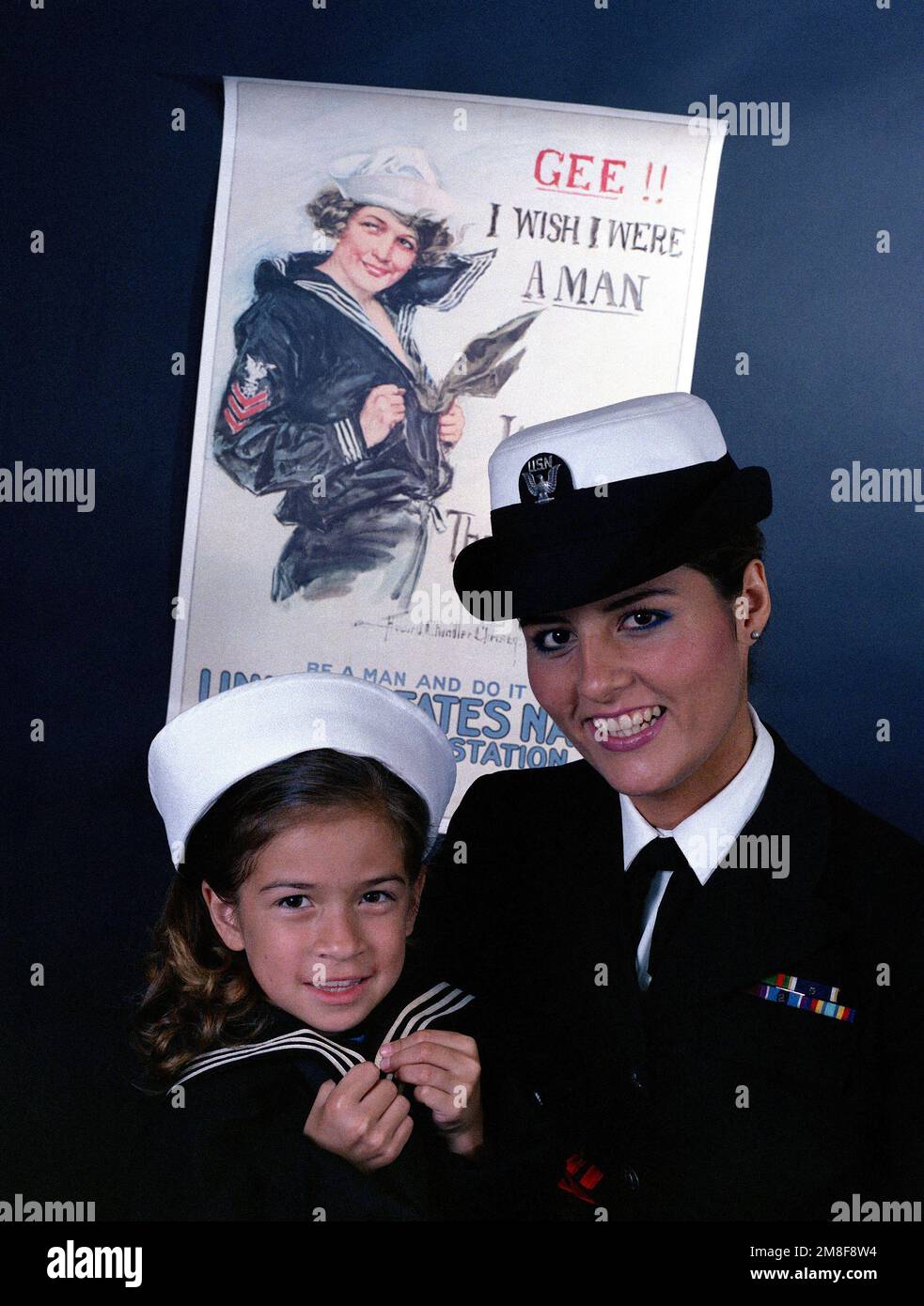 PN3 Clara Gardner and her daughter pose in front of a Navy recruiting ...